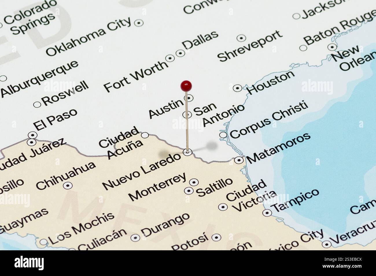 Macro photo of a red pin needle into Nuevo Laredo city of Mexico ...