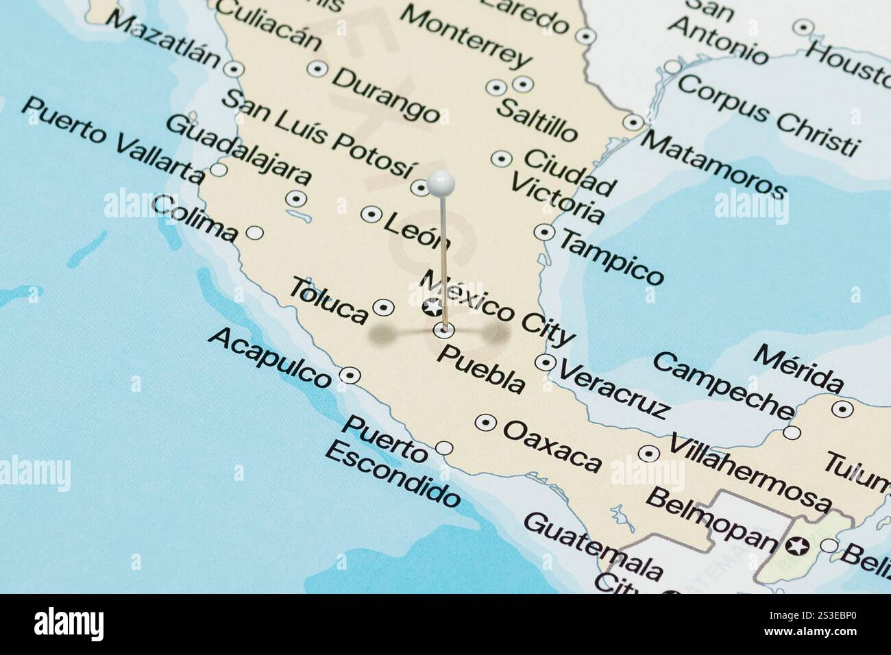 Macro photo of a white pin needle into Puebla city of Mexico political ...