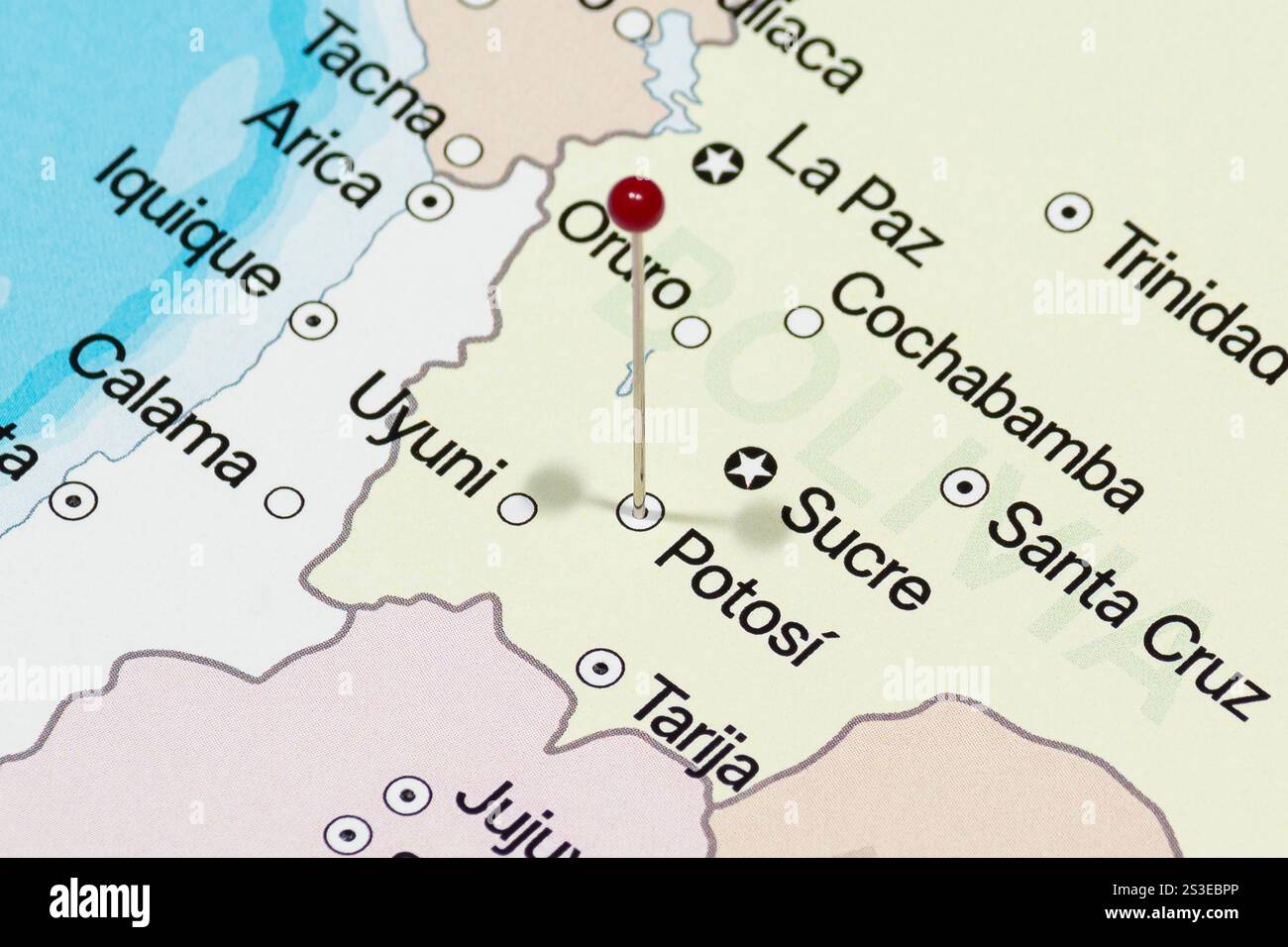 Macro photo of a red pin needle into potosi city of Bolivia political ...