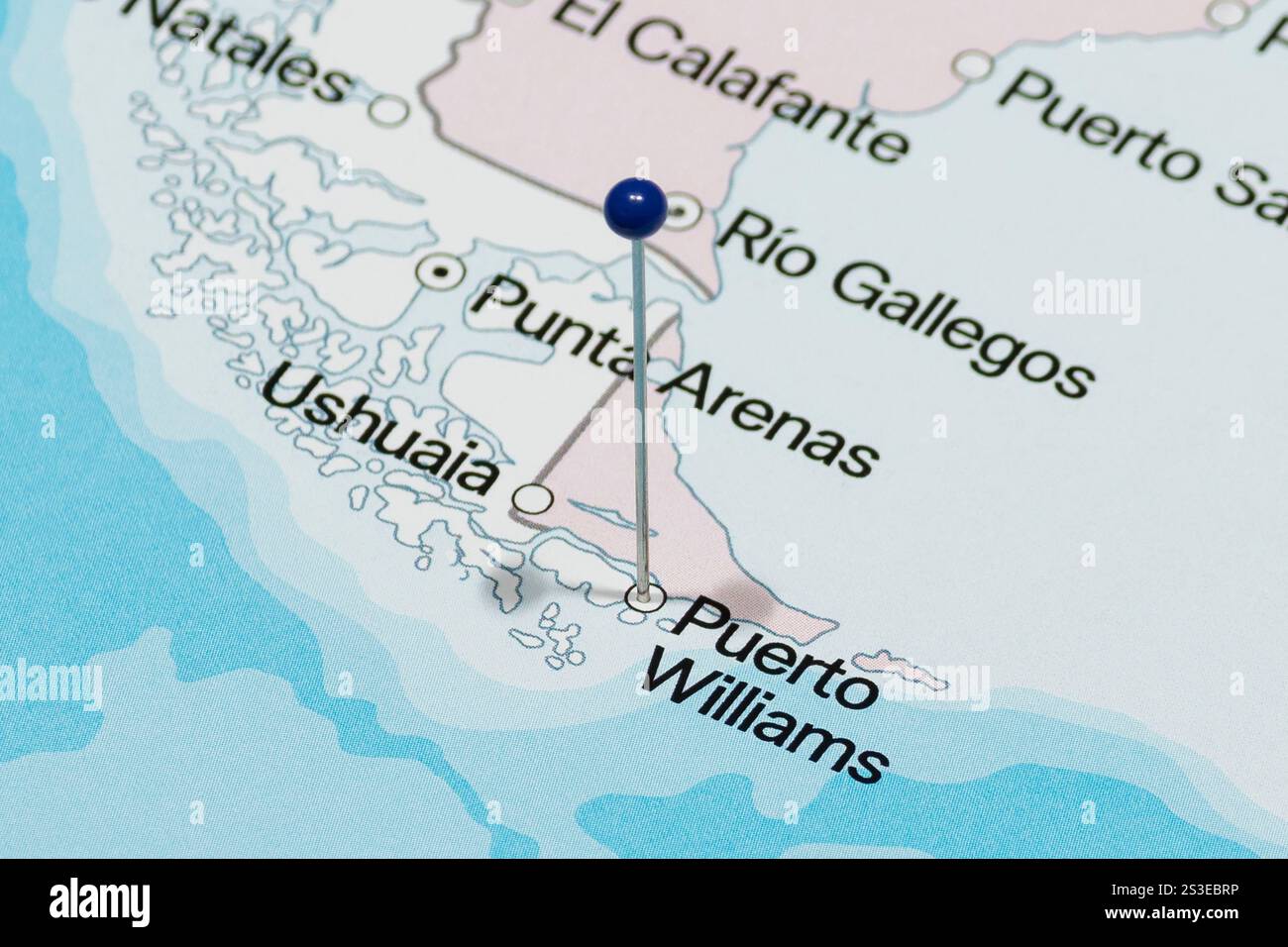 Macro photo of a blue pin needle into Puerto Williams city of Chile ...