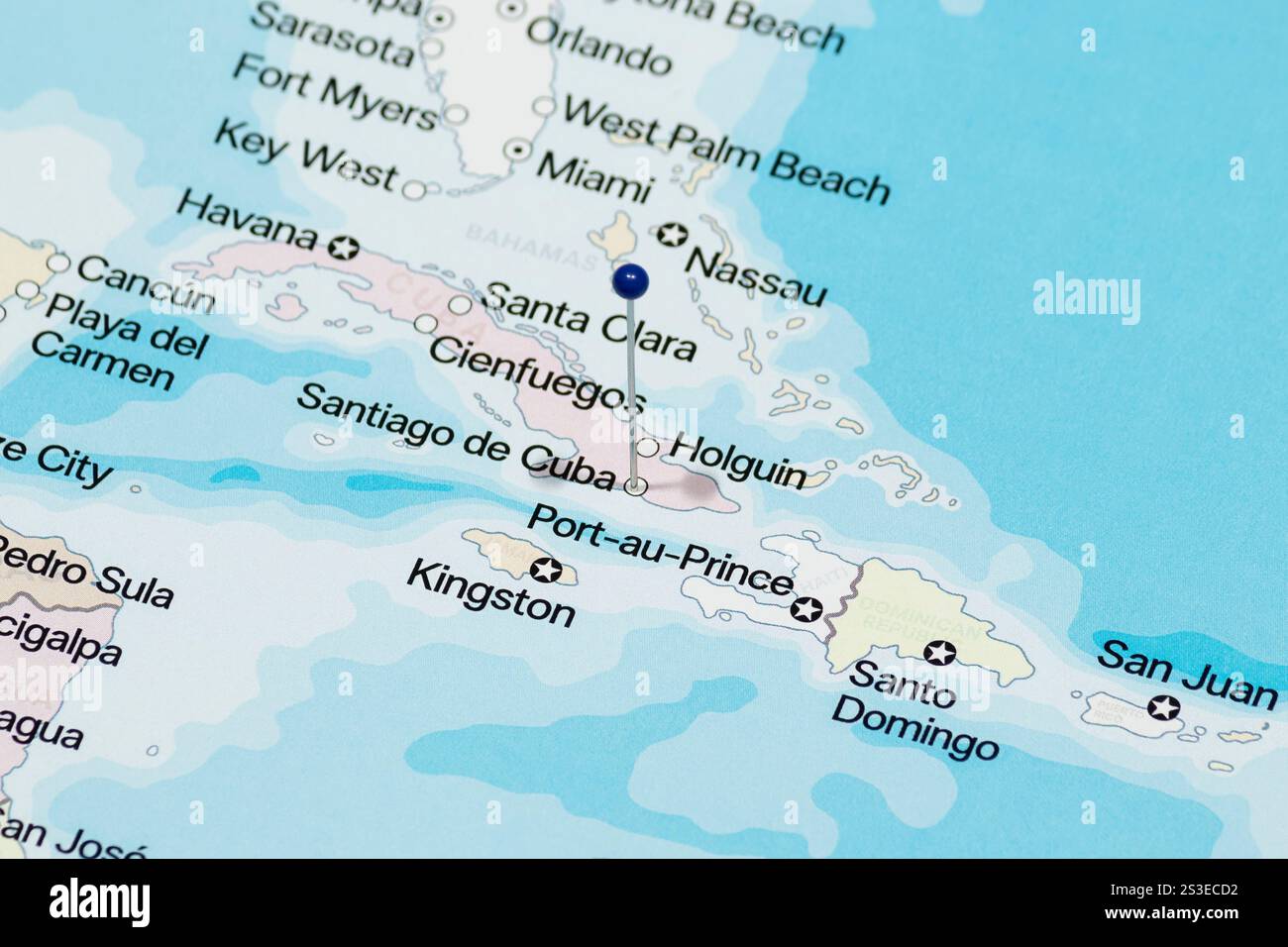 Macro photo of a blue pin needle into Santiago de Cuba city of Cuba ...