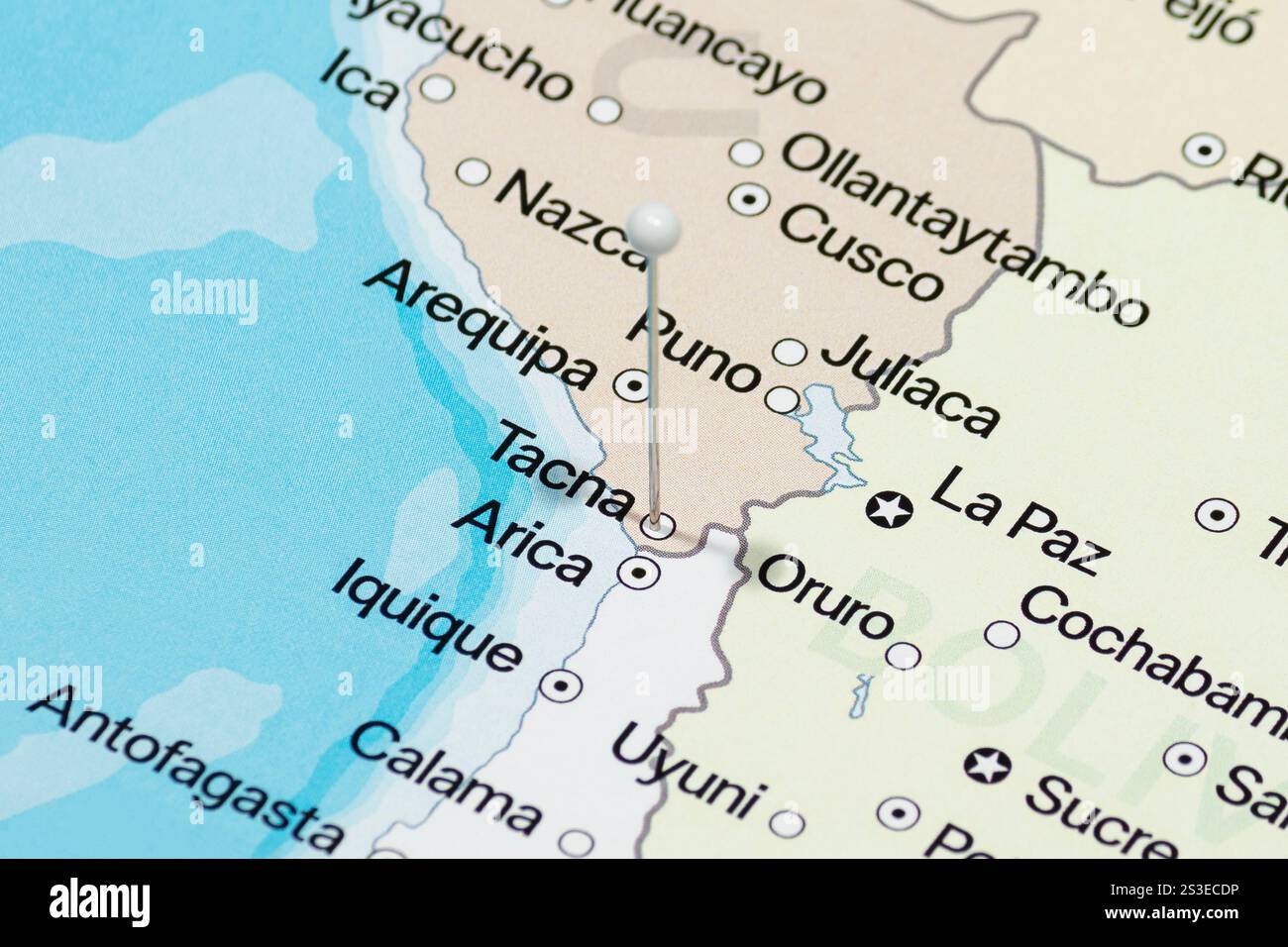 Macro photo of a white pin needle into Tacna city of Peru political map ...