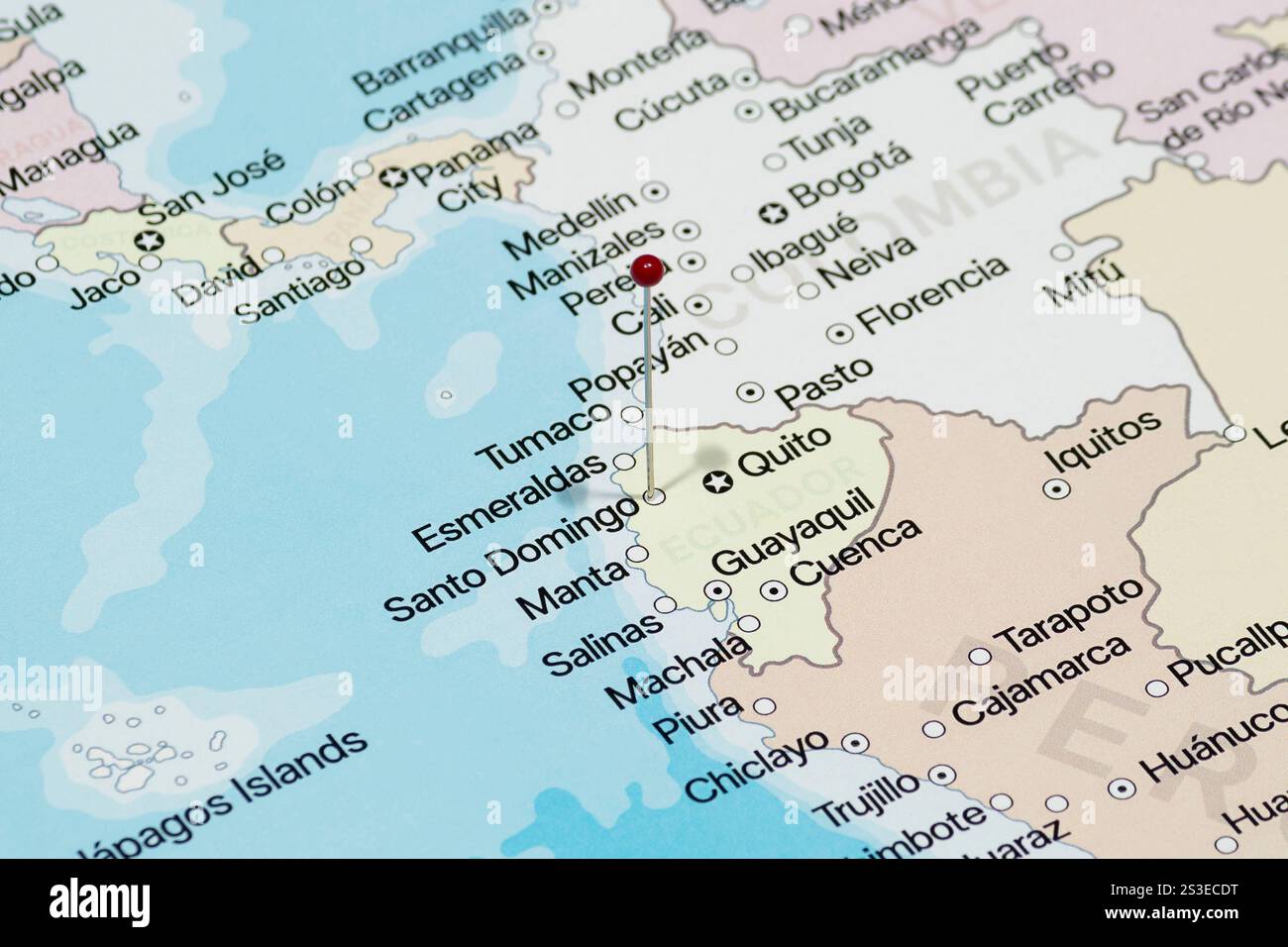 Macro photo of a red pin needle into Santo Domingo city of Ecuador ...