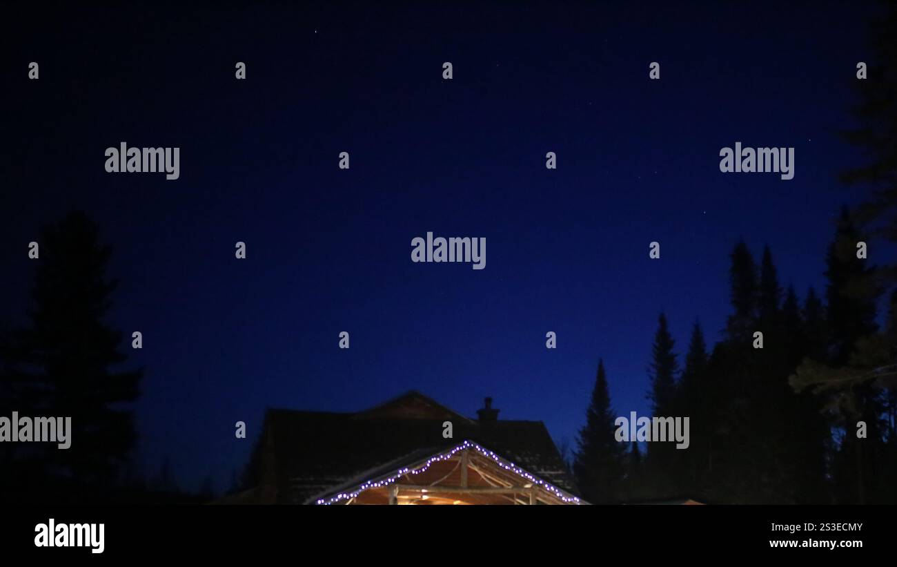 Christmas Card Night Sky Treeline and Cabin with Lights Background with ...