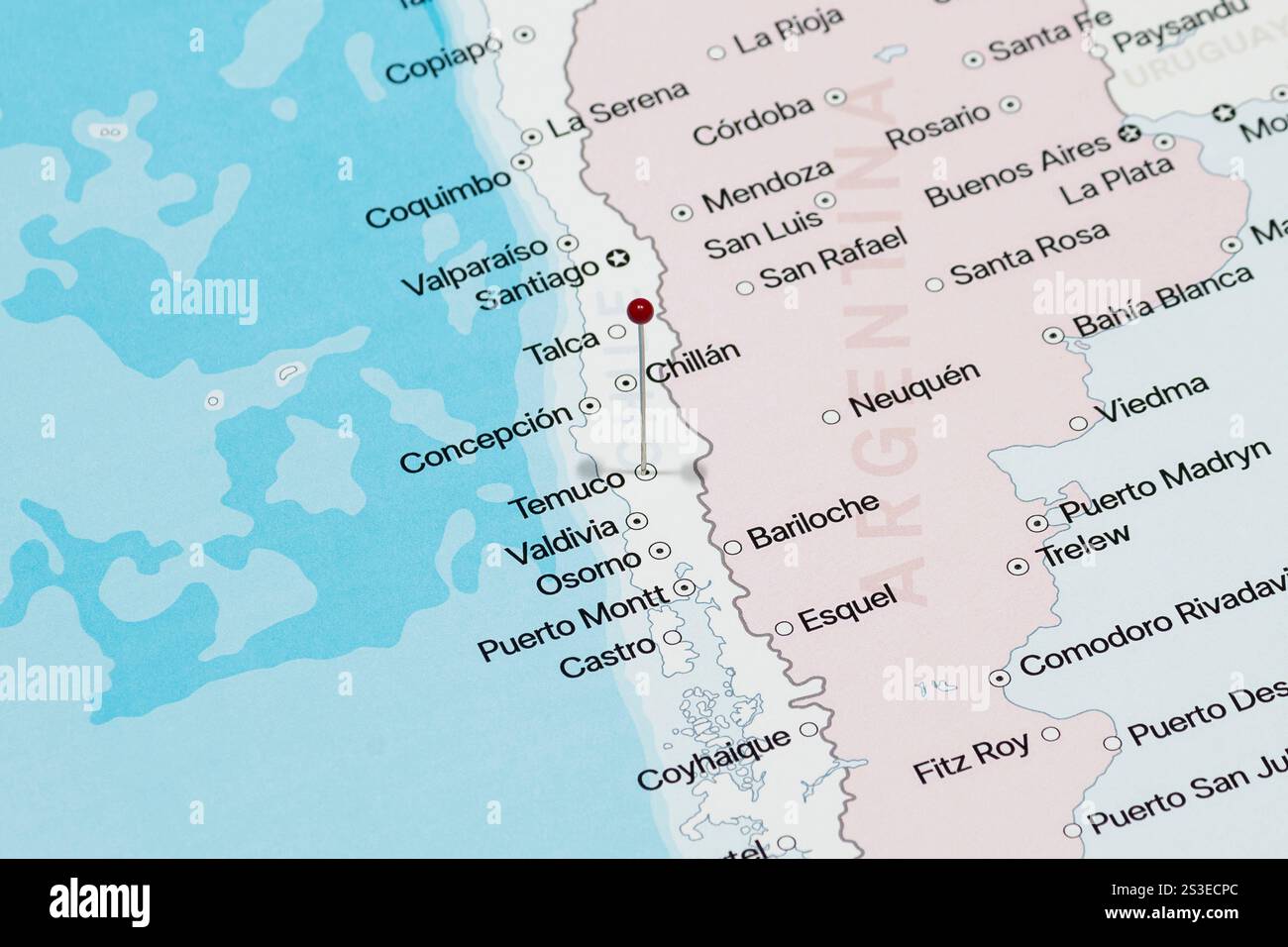 Macro photo of a red pin needle into Temuco city of Chile political map ...