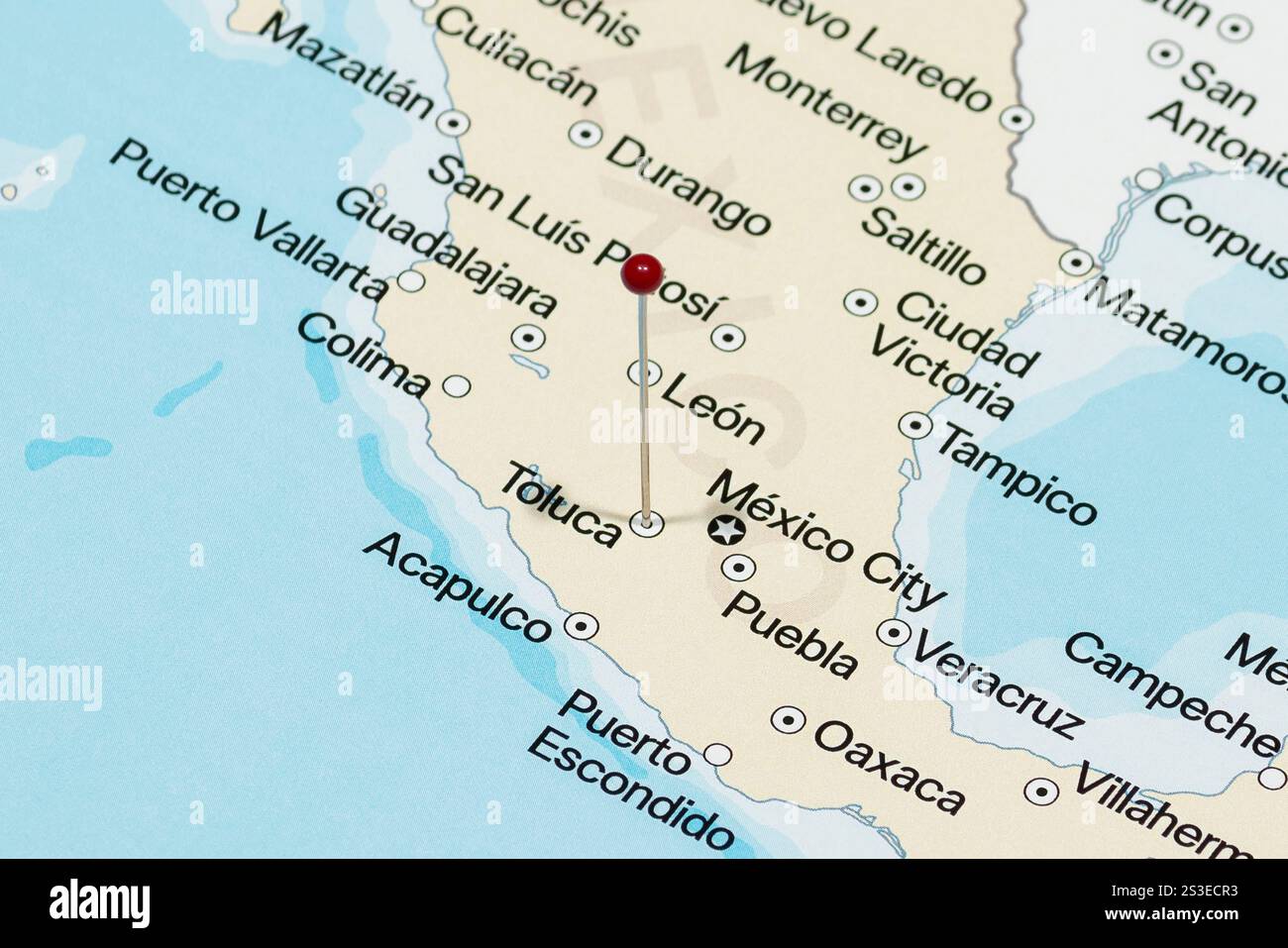 Macro photo of a red pin needle into Toluca city of Mexico political ...