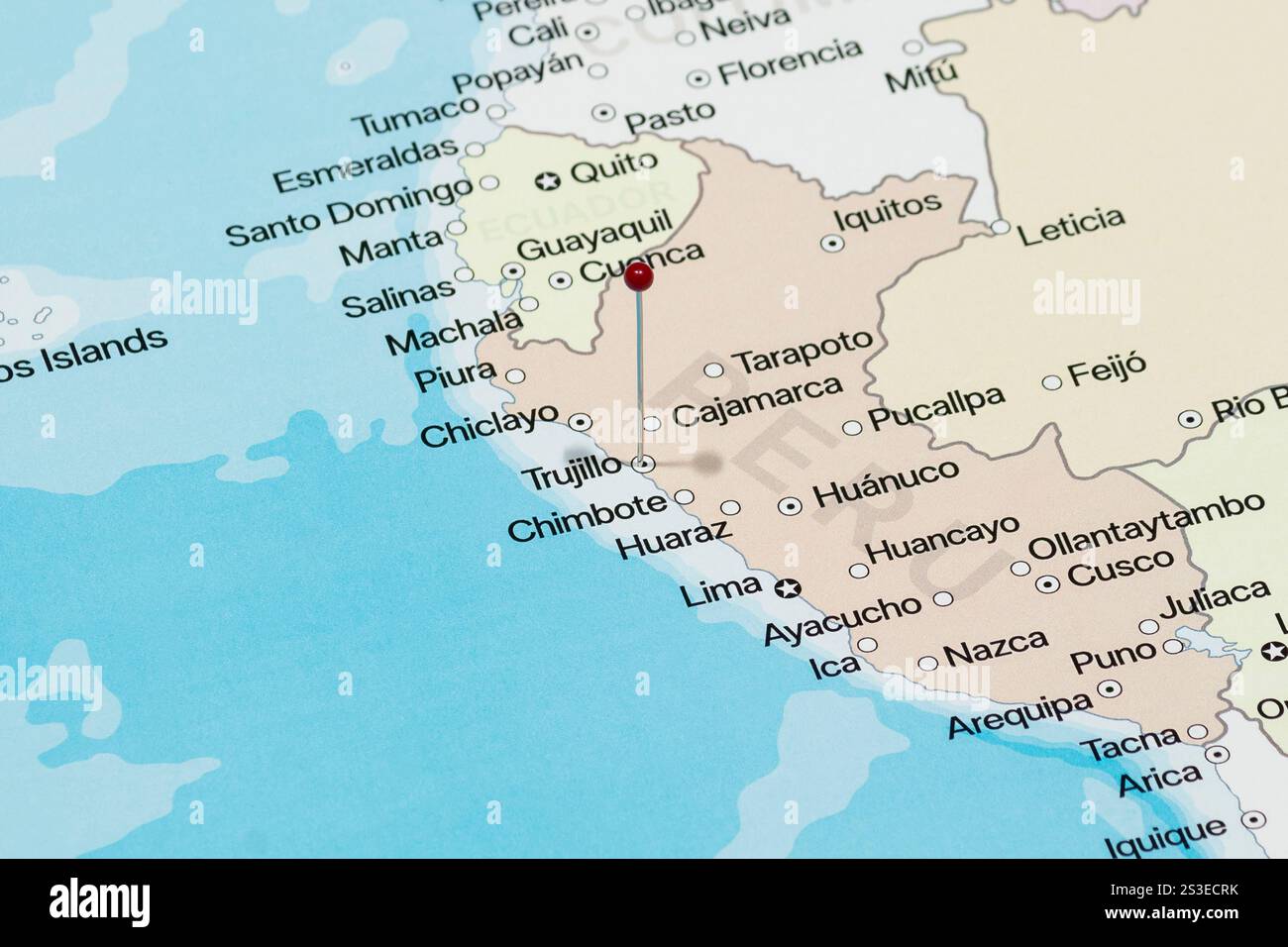 Macro photo of a red pin needle into Trujillo city of Peru political ...