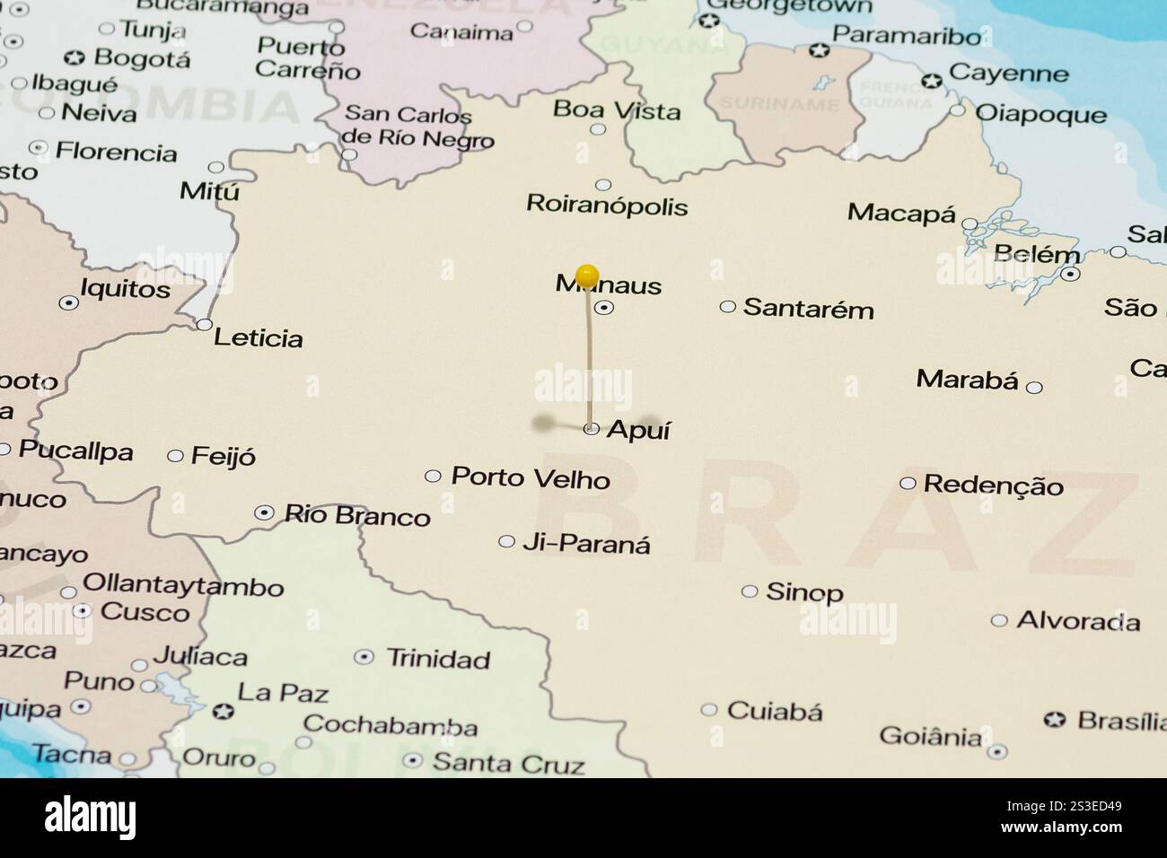 Macro photo of a yellow pin needle into apui city of Brazil political ...