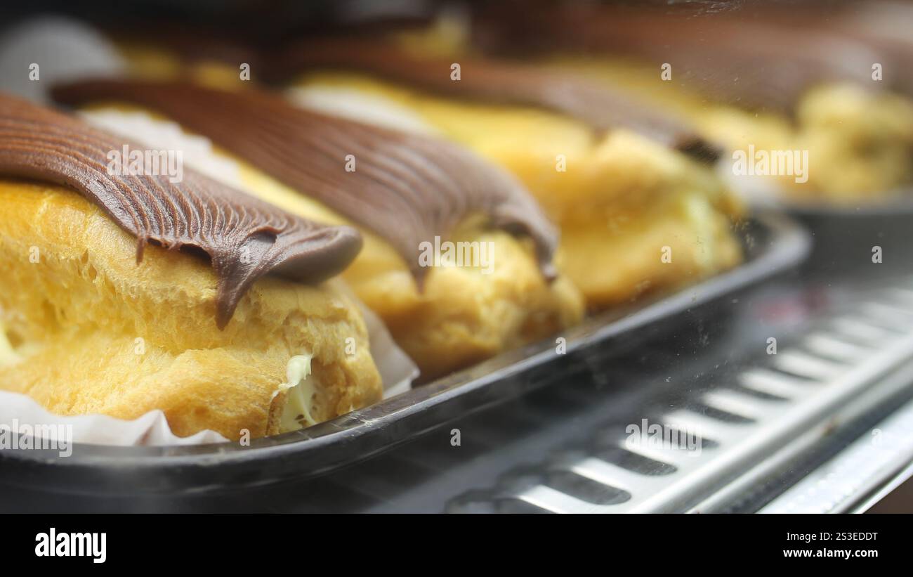 Bakery Eclairs on Cafe Rack Stock Photo - Alamy