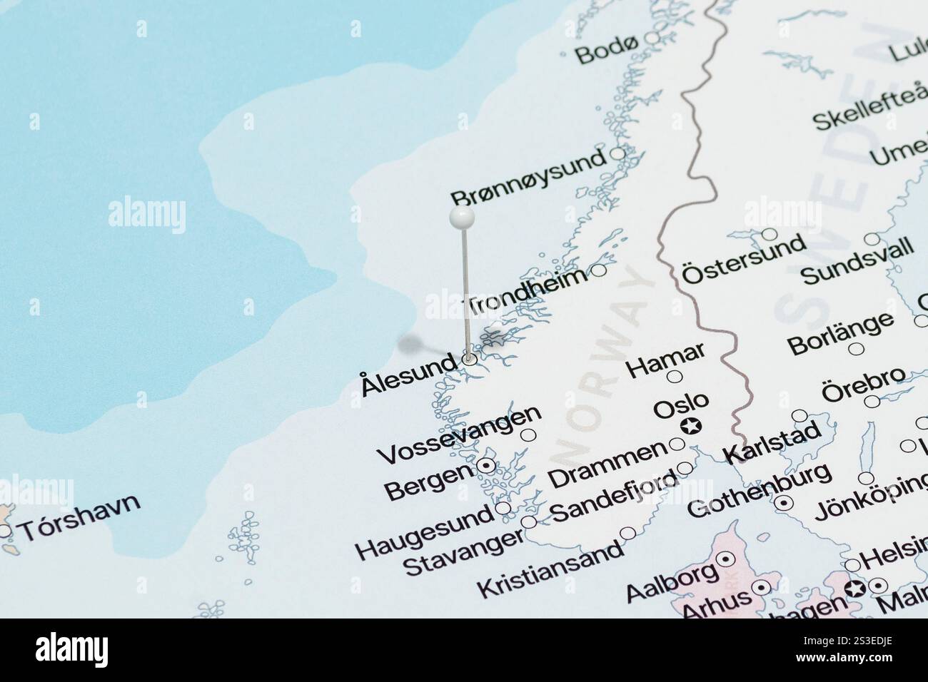 Macro photo of a white pin needle into Alesund city of Norway political ...