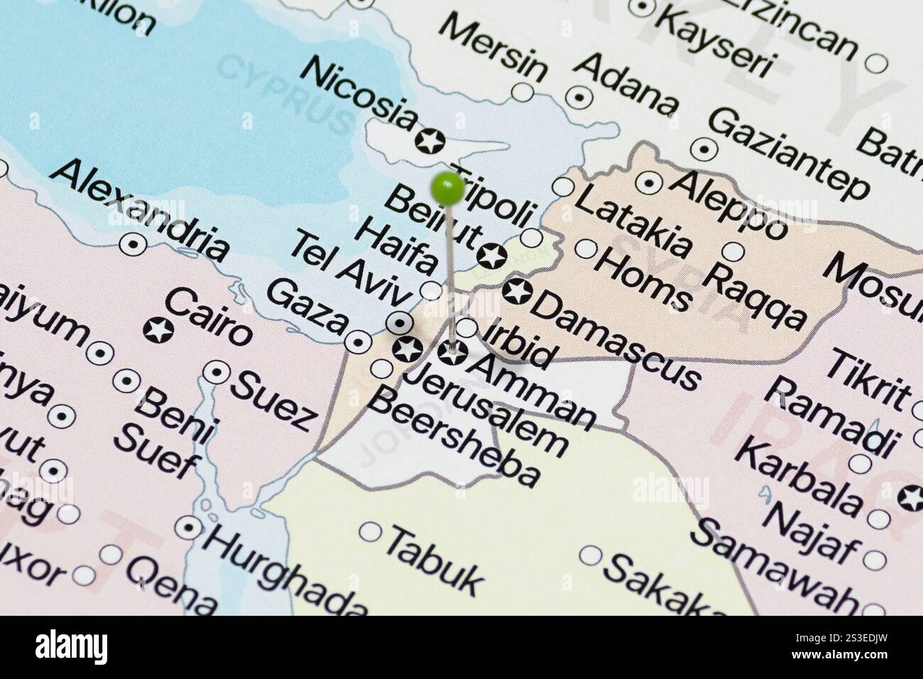 Macro photo of a green pin needle into Amman city of Jordan political ...