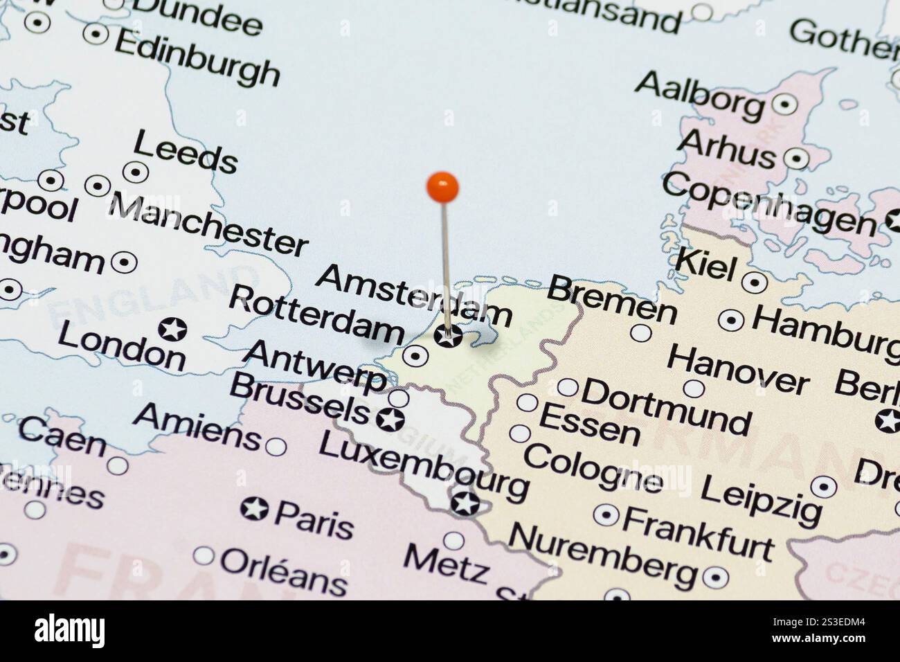 Macro photo of an orange pin needle into Amsterdam city of netherlands ...
