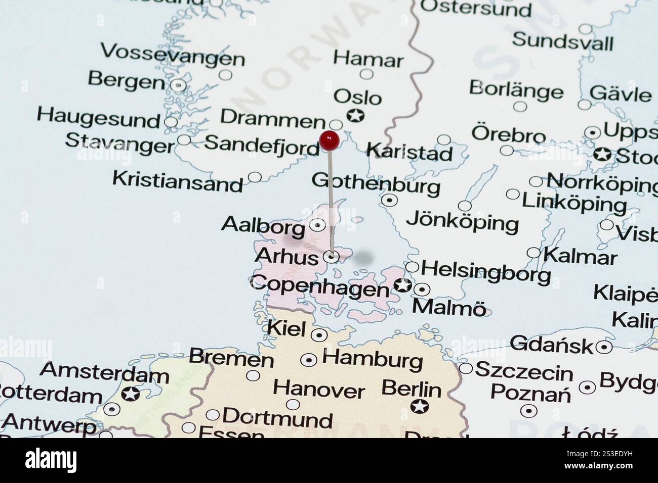 Macro photo of a red pin needle into Aarhus city of Denmark political ...