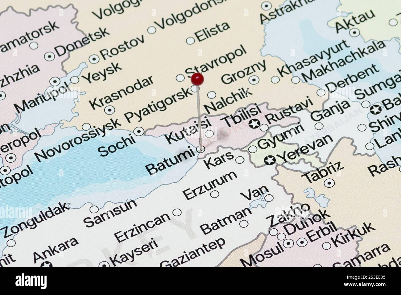 Macro photo of a red pin needle into Batumi city of Georgia political ...