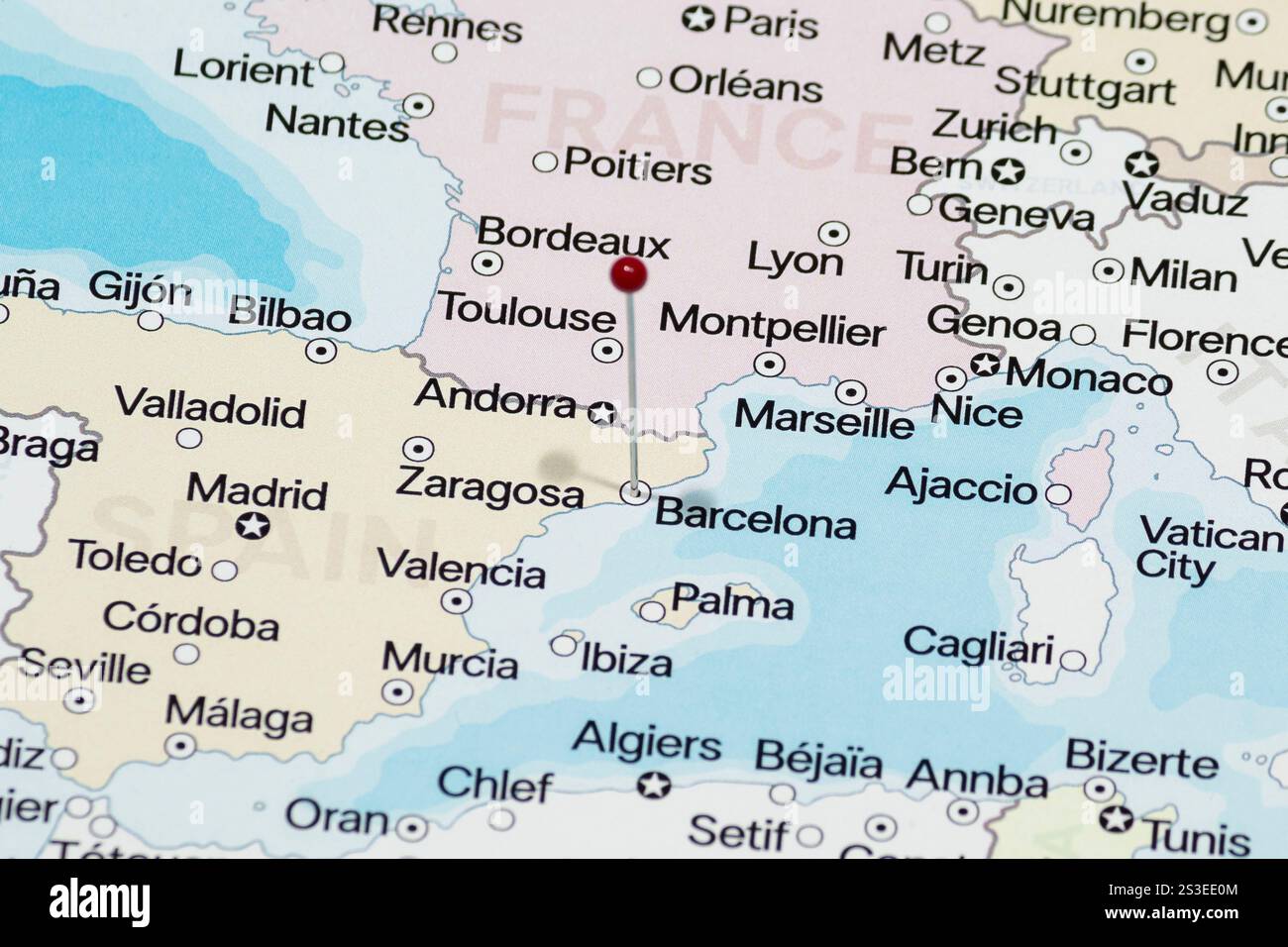 Macro photo of a red pin needle into Barcelona city of Spain political ...