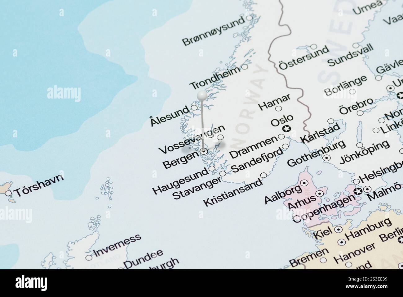 Macro photo of a white pin needle into Bergen city of Norway political ...