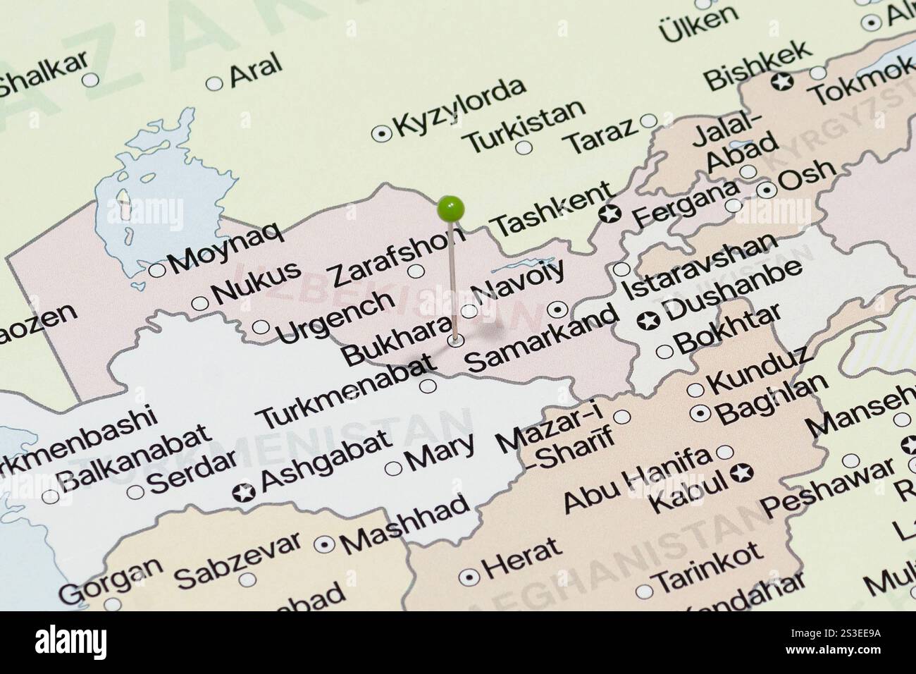 Macro photo of a green pin needle into Bukhara city of Uzbekistan ...