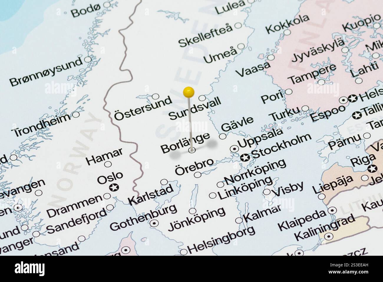 Macro photo of a yellow pin needle into Borlange city of Sweden ...