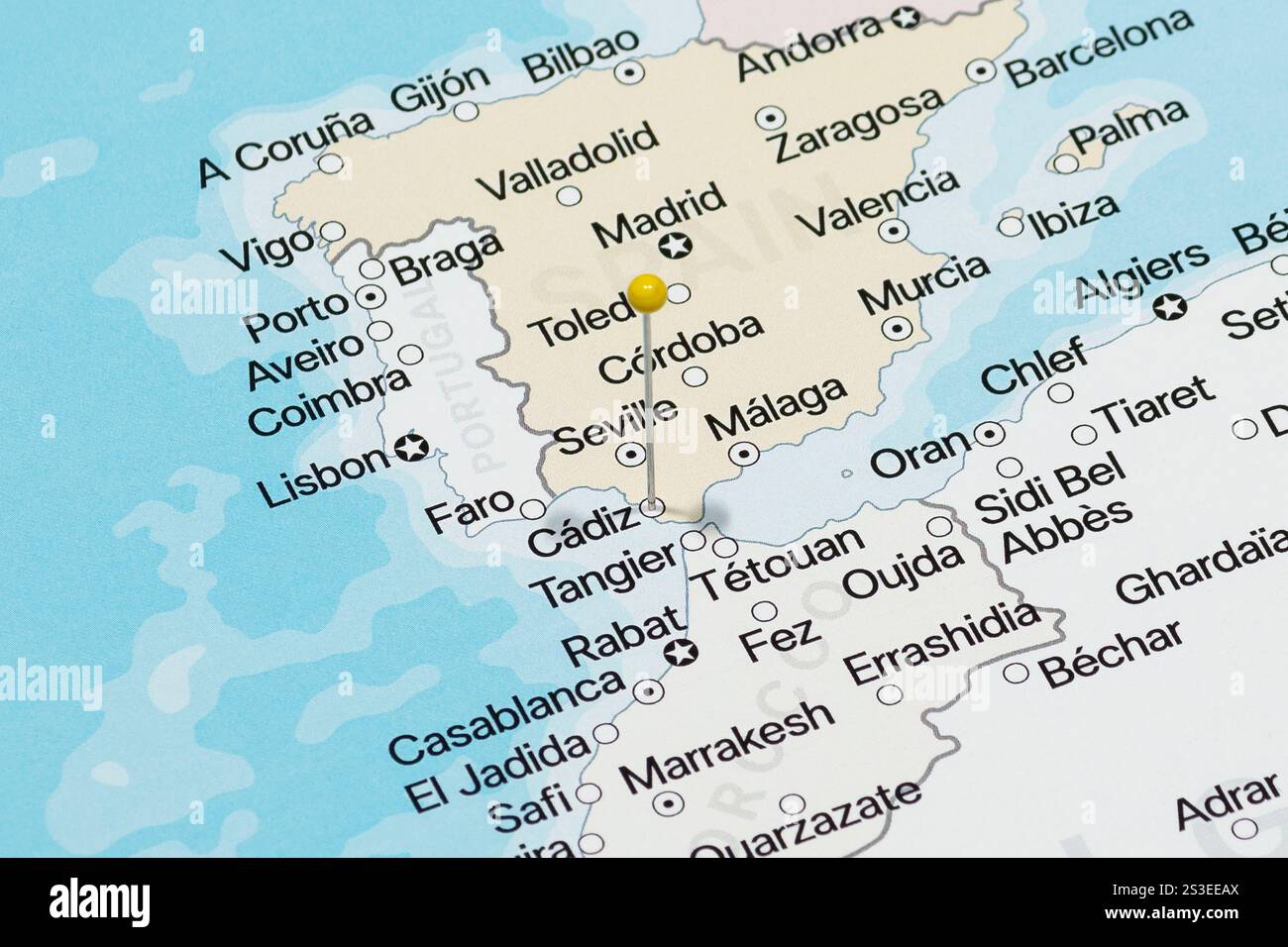 Macro photo of a yellow pin needle into Cadiz city of Spain political ...