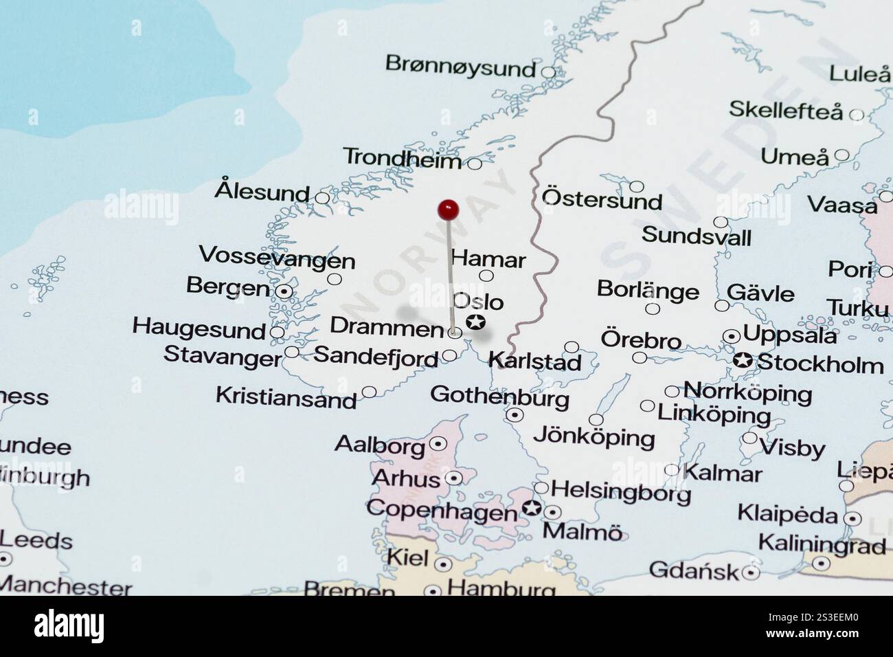 Macro photo of a red pin needle into Drammen city of Norway political ...