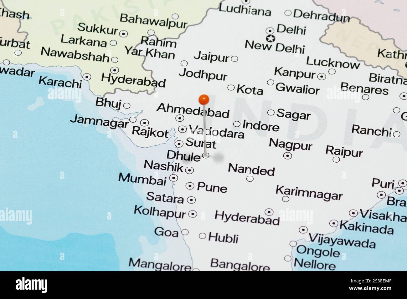 Macro photo of an orange pin needle into Dhule city of India political ...