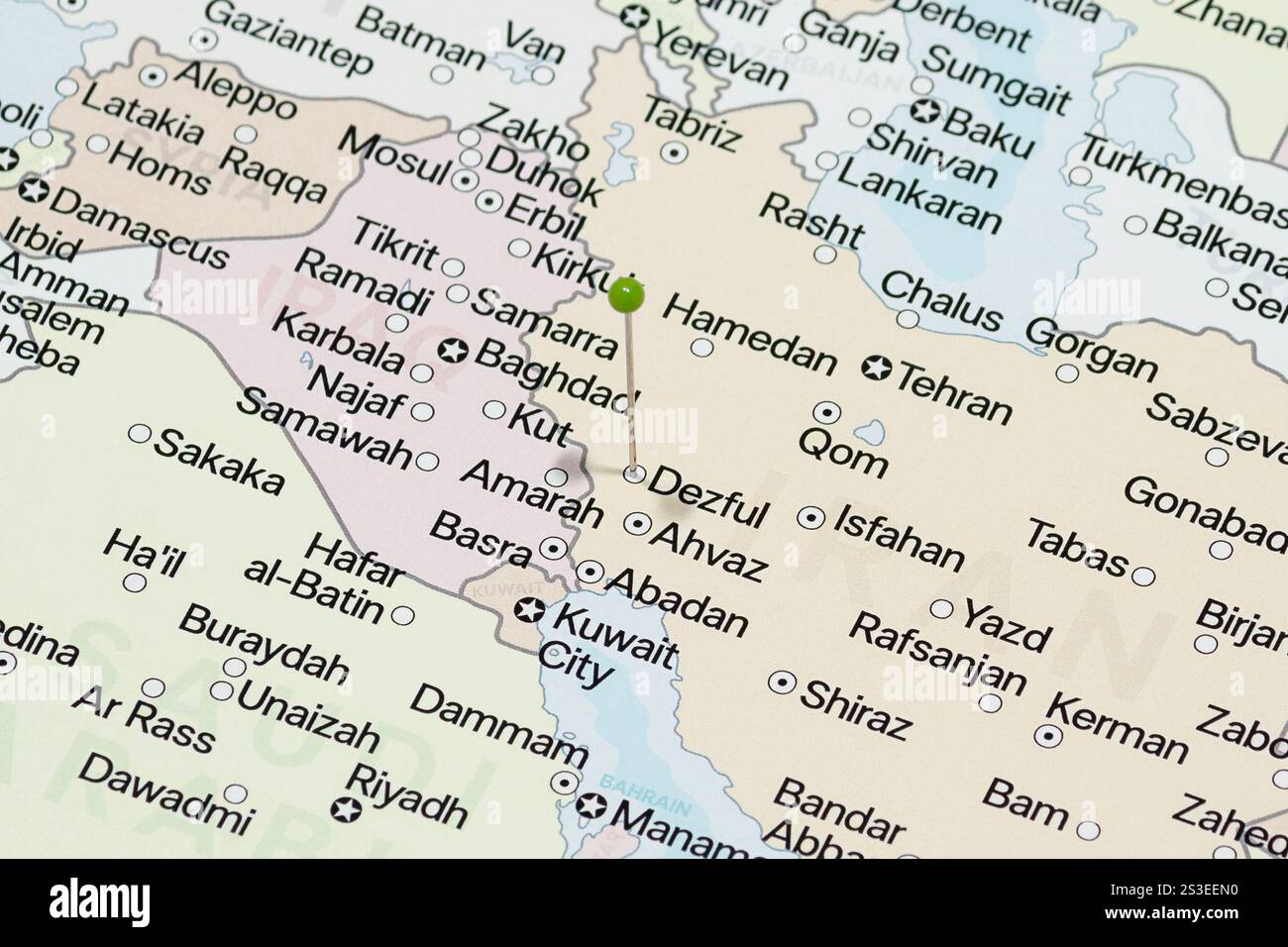 Macro photo of a green pin needle into Dezful city of Iran political ...