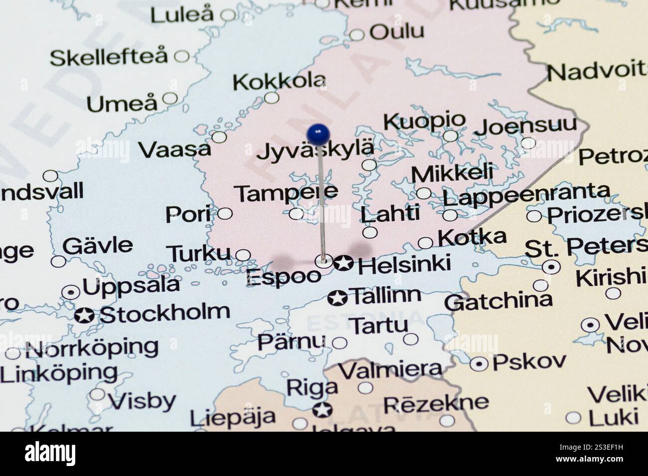 Macro photo of a blue pin needle into Espoo city of Finland political ...