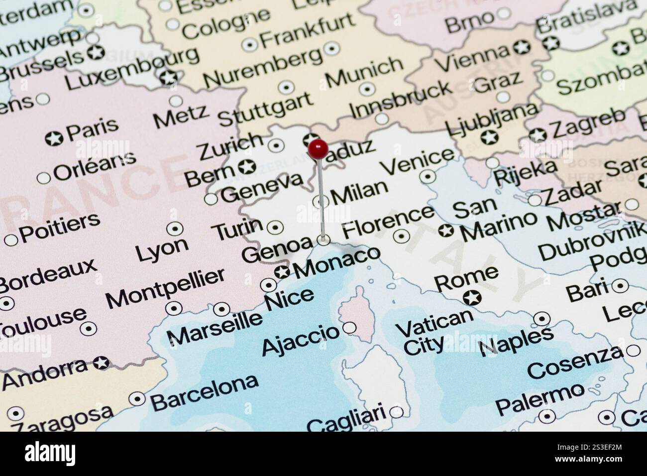 Macro photo of a red pin needle into Genoa city of Italy political map ...