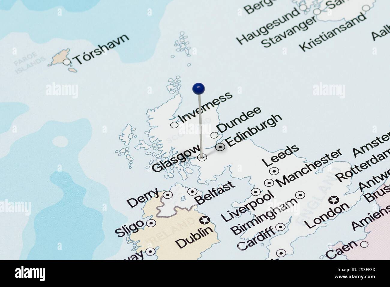 Macro photo of a blue pin needle into Glasgow city of Scotland ...