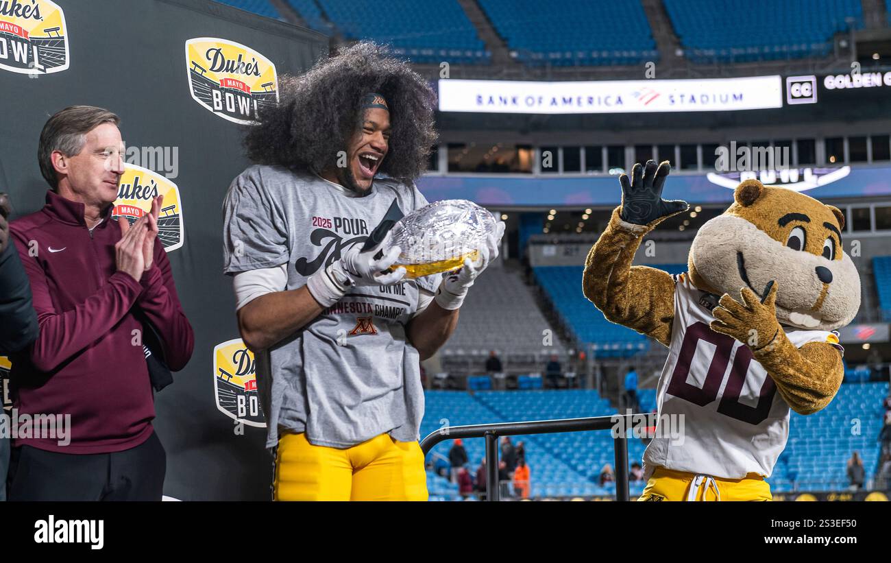 Minnesota wide receiver Elijah Spencer (11) receives trophy after being ...