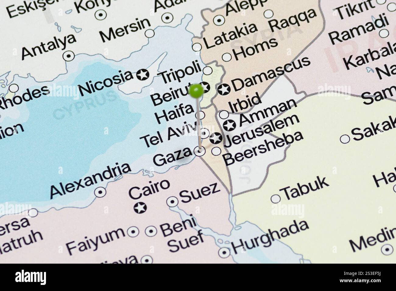 Macro photo of a green pin needle into Gaza city of Palestine political ...