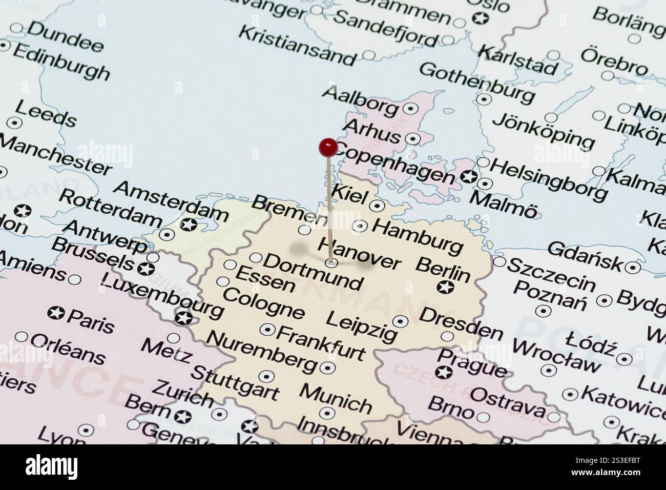 Macro photo of a red pin needle into Hanover city of Germany political ...