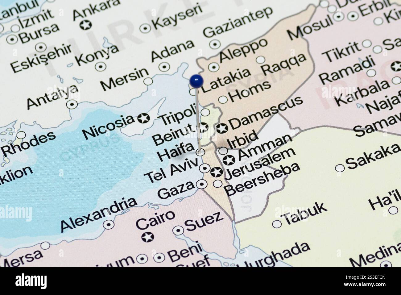 Macro photo of a blue pin needle into Haifa city of Israel political ...