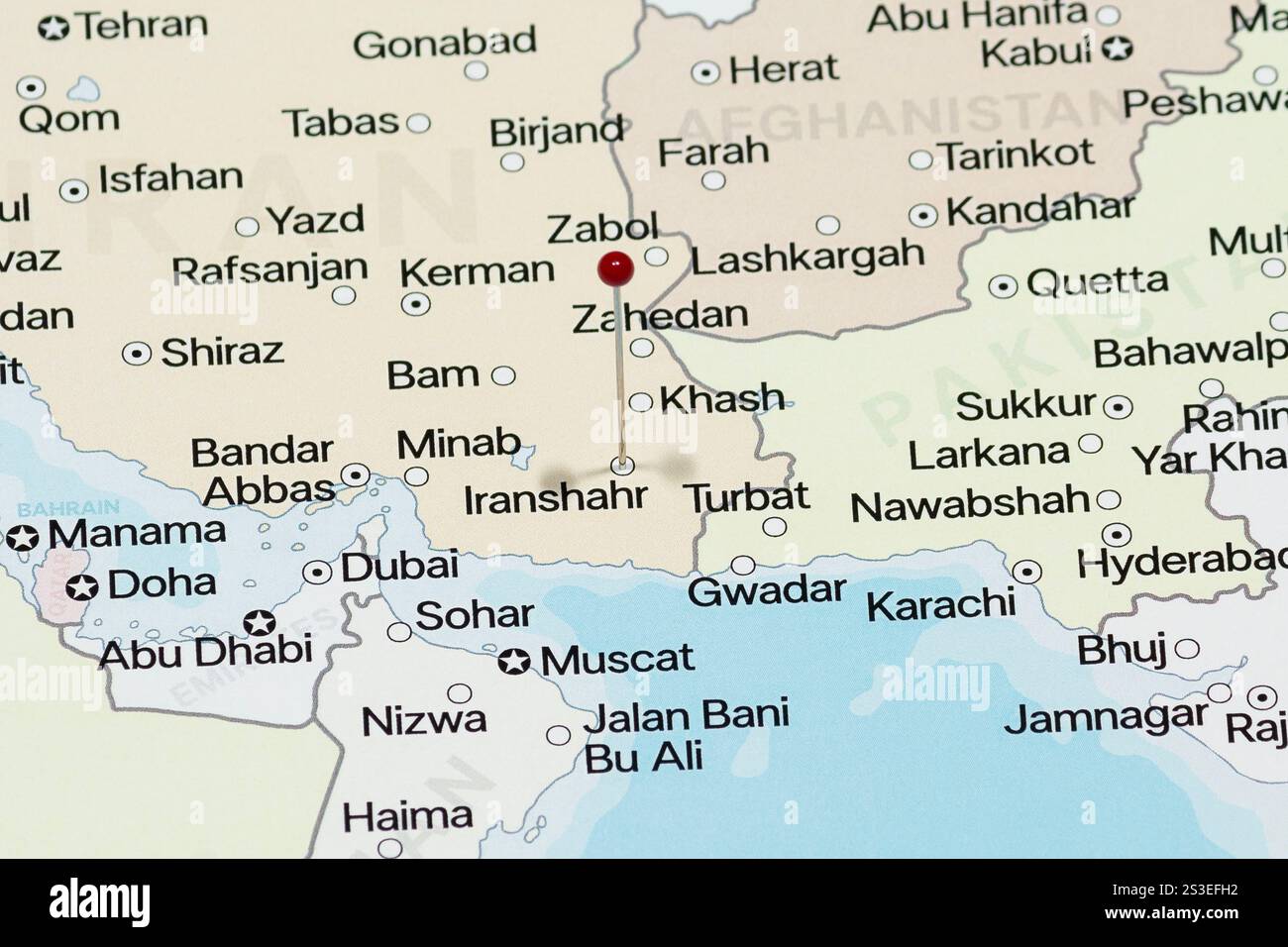 Macro photo of a red pin needle into Iranshahr city of Iran political ...