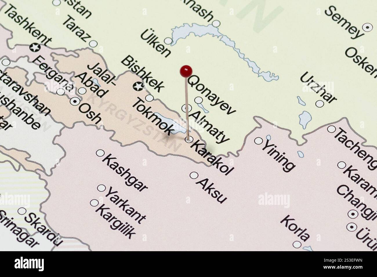 Macro photo of a red pin needle into Karakol city of Kyrgyzstan ...