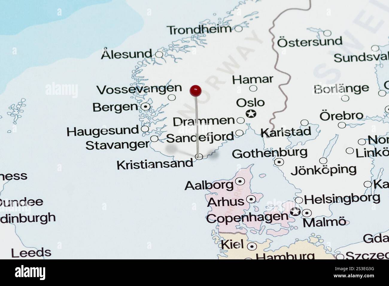 Macro photo of a red pin needle into Kristiansand city of Norway ...