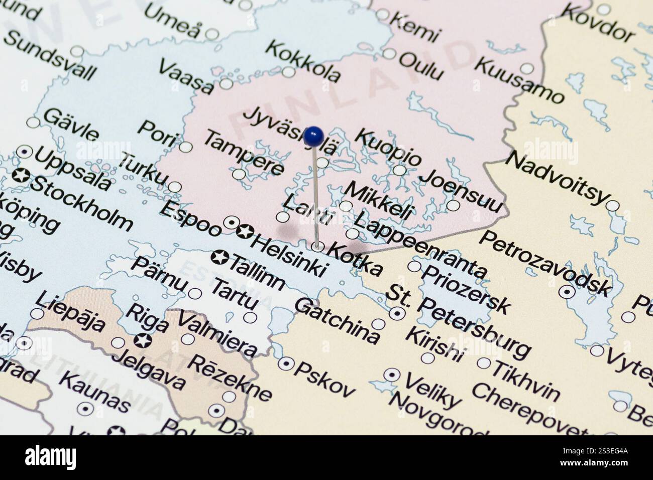 Macro photo of a blue pin needle into Kotka city of Finland political ...