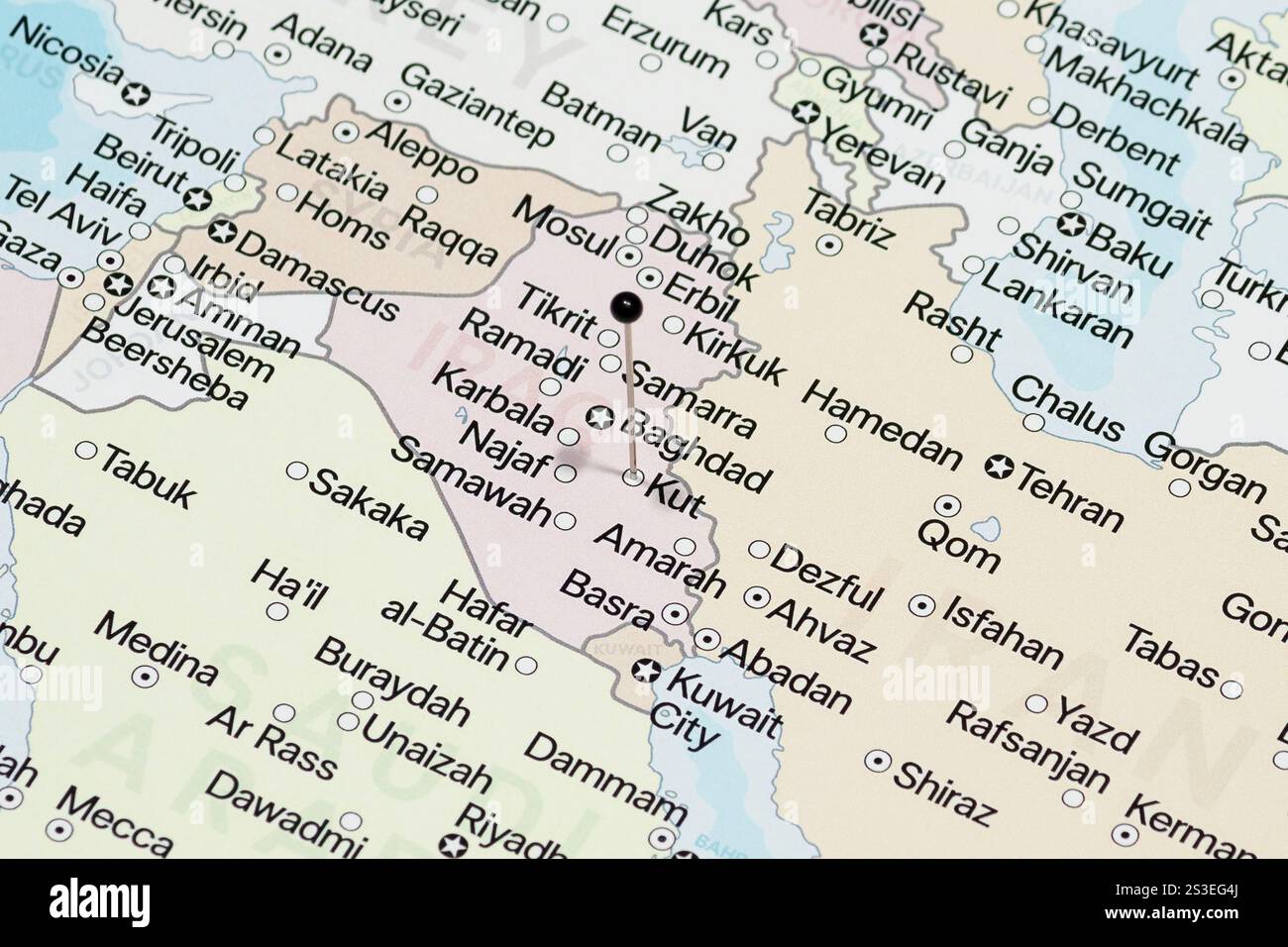 Macro photo of a black pin needle into Kut city of Iraq political map ...