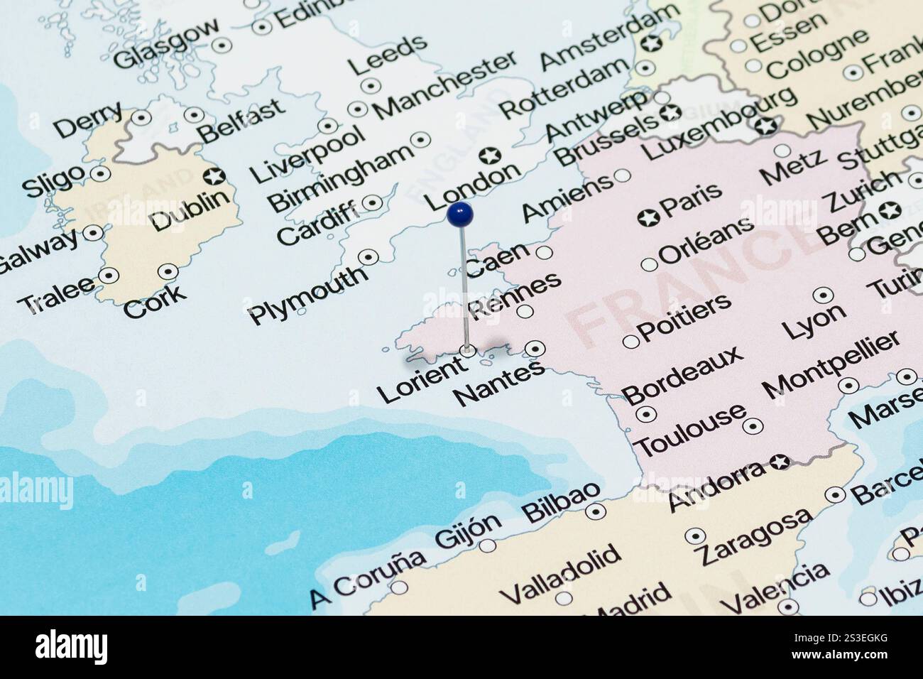 Macro photo of a blue pin needle into Lorient city of France political ...