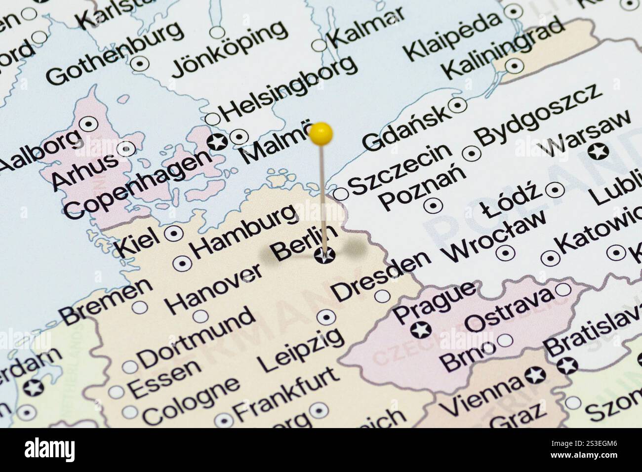 Close up to a yellow pin needle into Berlin city of Germany political ...