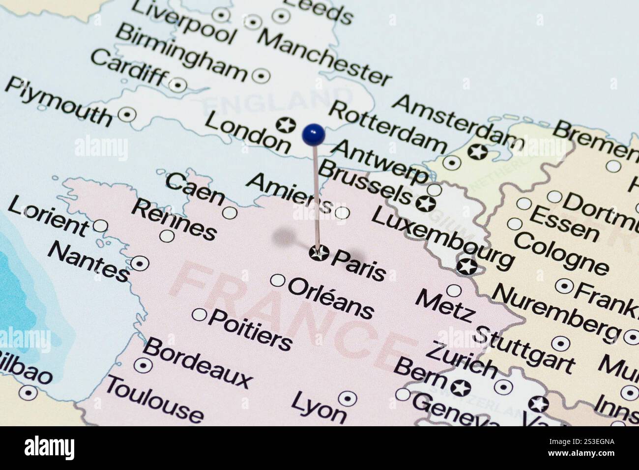 Close up to a blue pin needle into Paris city of France political map ...