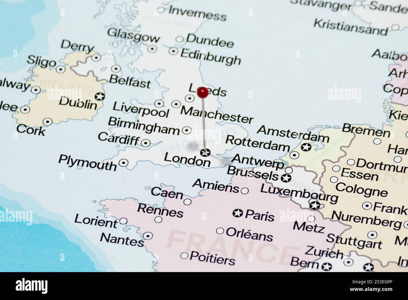 Close up to a red pin needle into London city of England political map ...