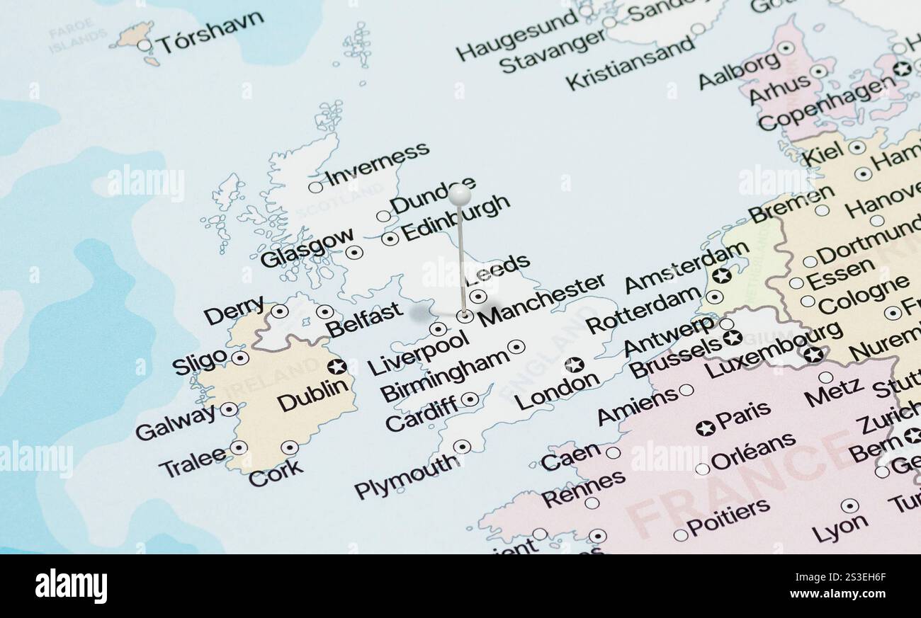 Macro photo of a white pin needle into Manchester city of England ...