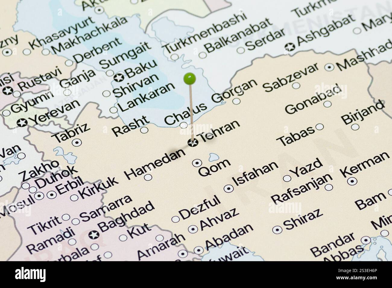 Close up to a green pin needle into Teheran city of Iran political map ...