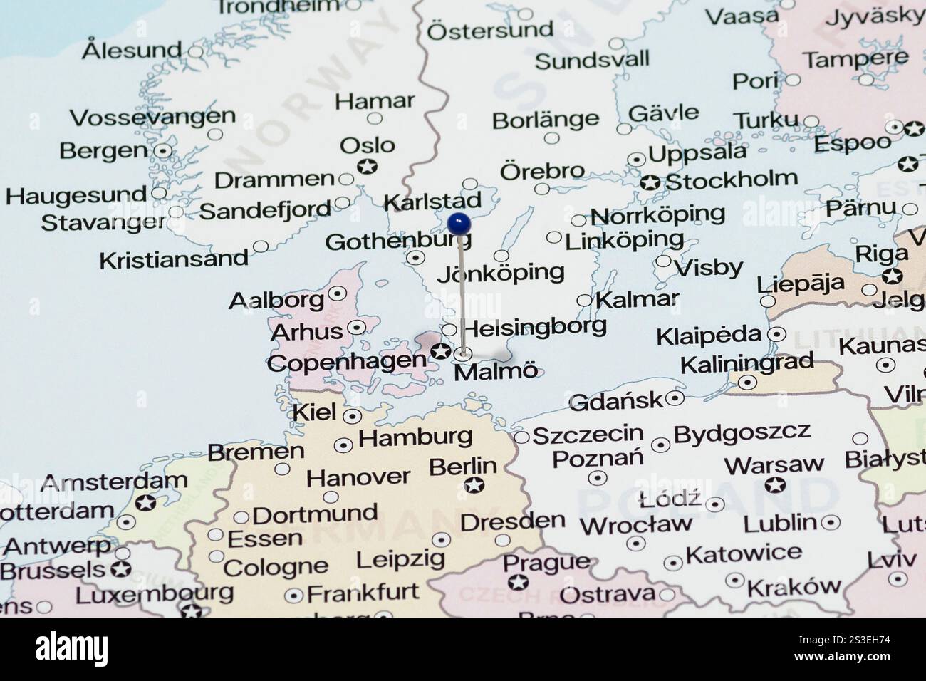 Macro photo of a blue pin needle into Malmö city of Sweden political ...