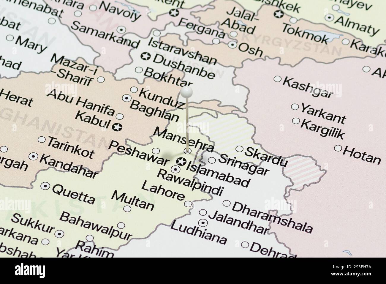 Macro photo of a white pin needle into Mansehra city of Pakistan ...