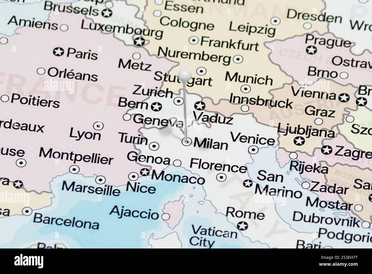 Macro photo of a white pin needle into Milan city of Italy political ...