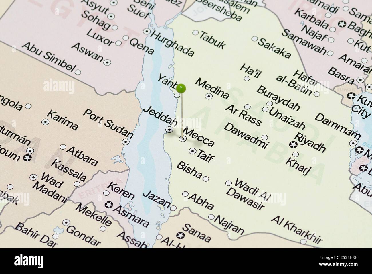 Macro photo of a green pin needle into Mecca city of Saudi Arabia ...