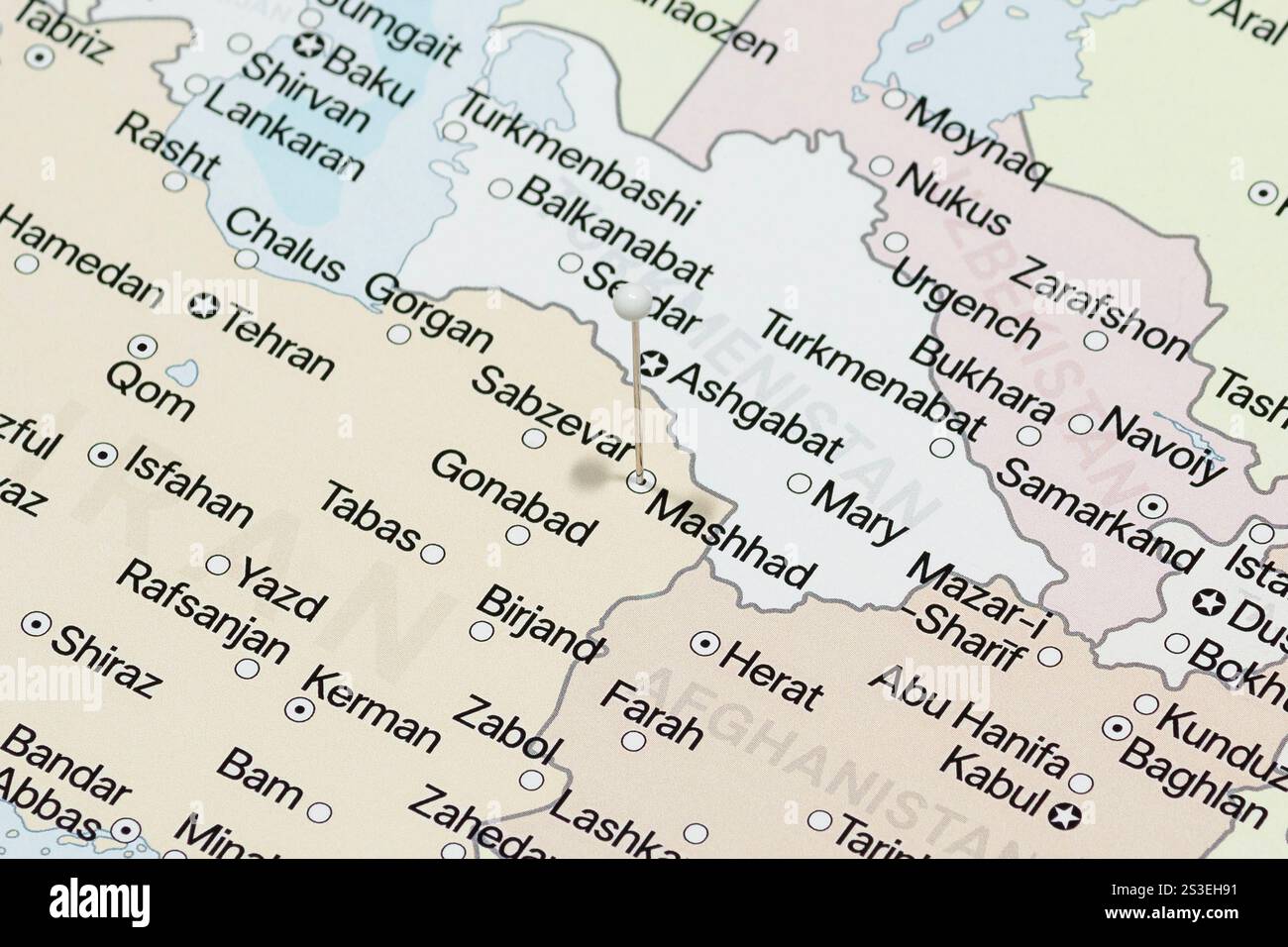 Macro photo of a white pin needle into Mashhad city of Iran political ...