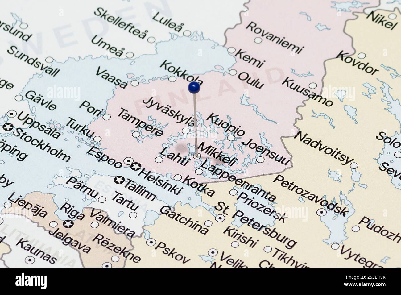 Macro photo of a blue pin needle into Mikkeli city of Finland political ...